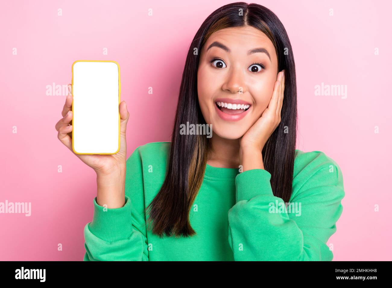 Photo of young funny excited japanese woman touch cheek hold empty ...