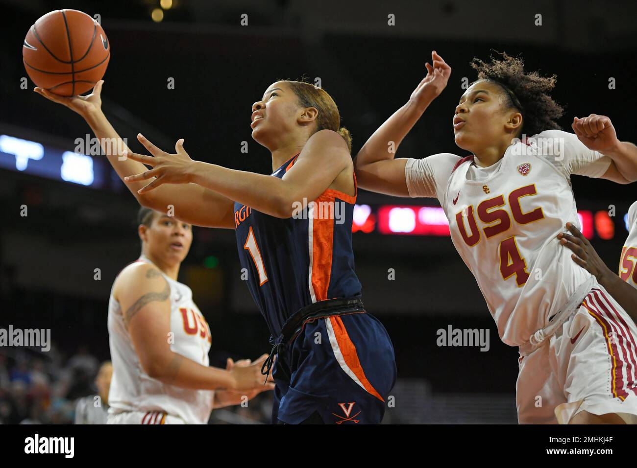 Virginia Cavaliers guard Carole Miller gets past USC Trojans guard ...
