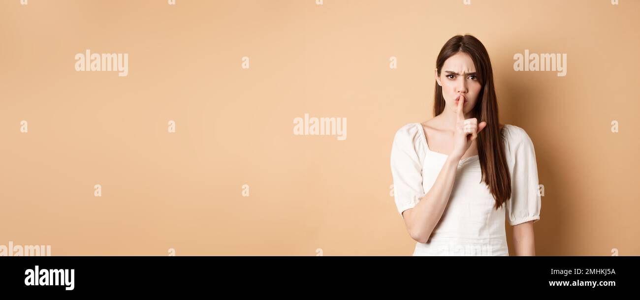 Angry young girl scolding bad behavious, shushing and frowning mad ...