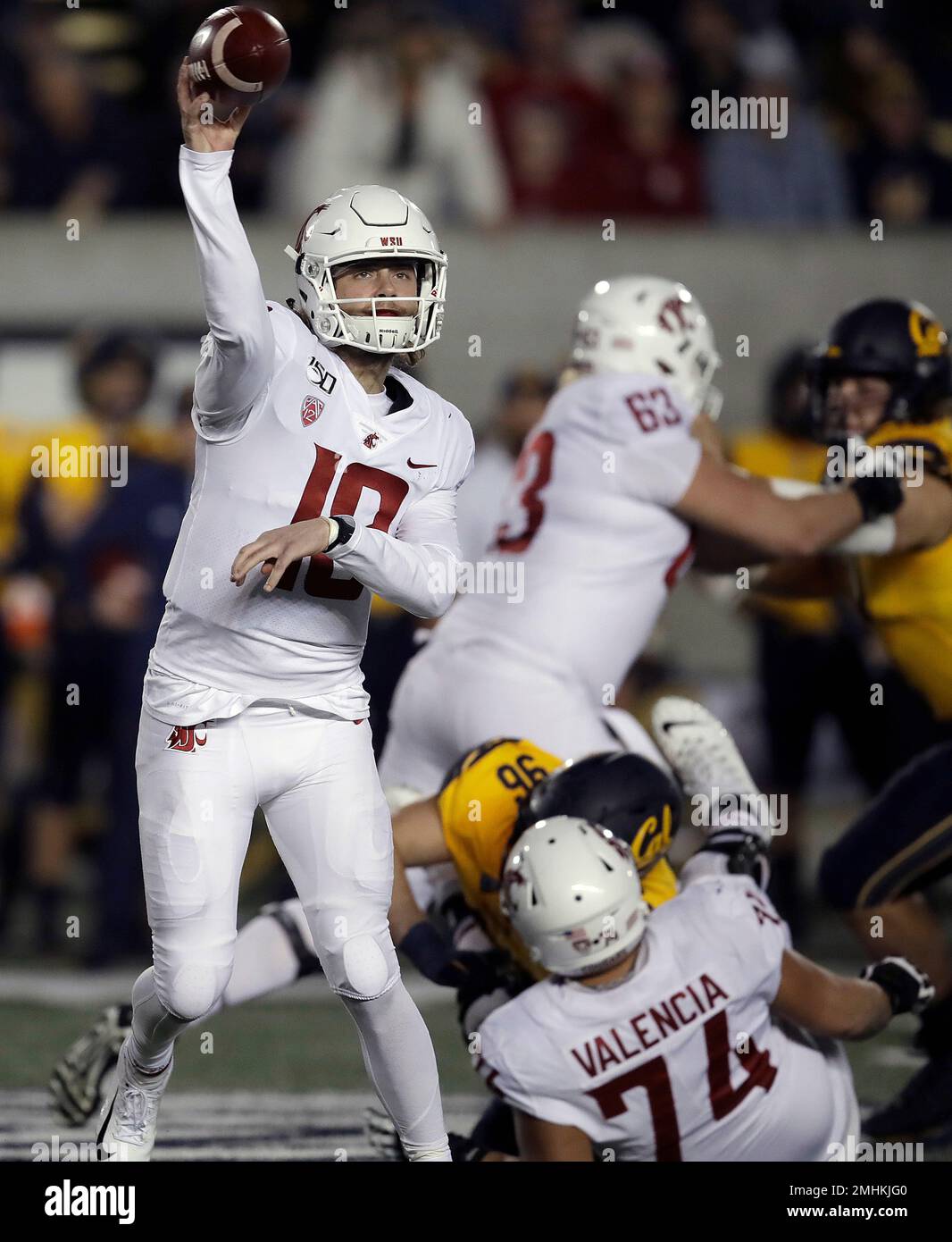Washington State quarterback Anthony Gordon, left, passes against ...