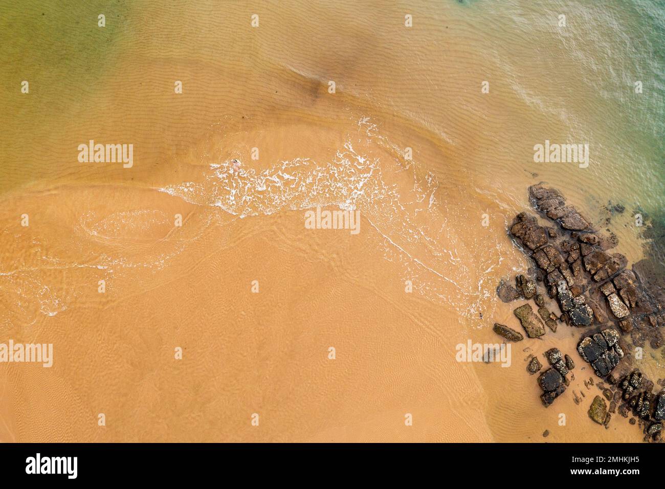Aerial view of the sand beach with dark rocks in Phu Quoc Island ...