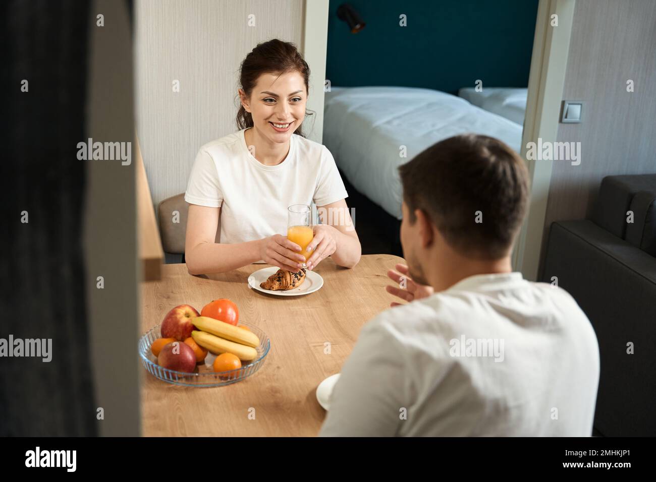 Cute man and woman sit opposite each other wooden table Stock Photo - Alamy