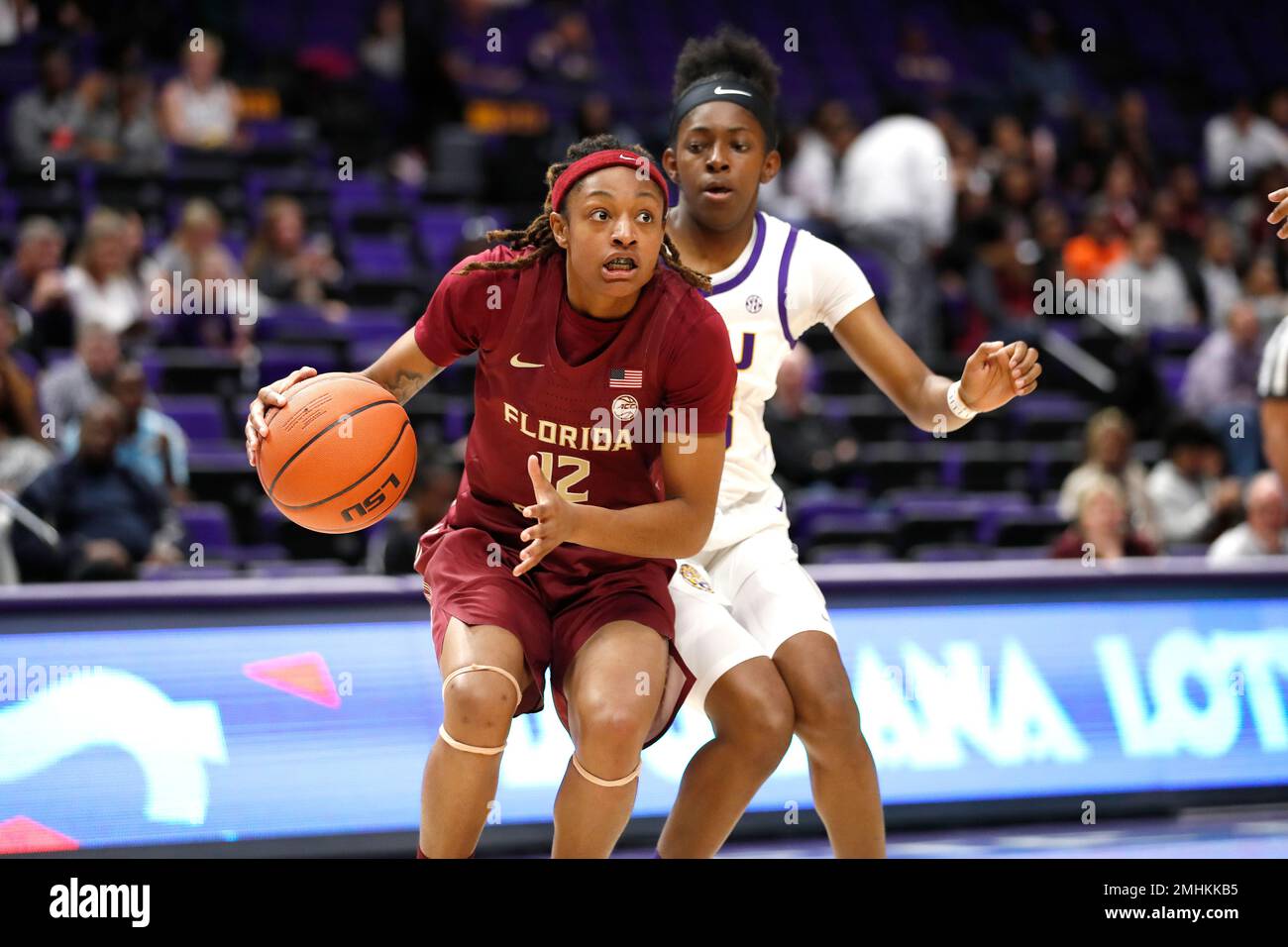 Florida St. guard Nicki Ekhomu (12) drives past LSU guard Karli Seay ...
