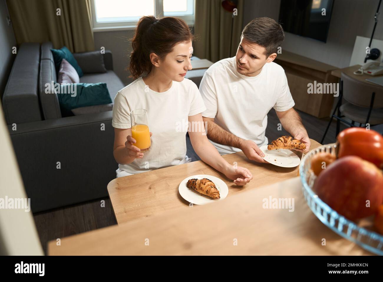 Pleasant young couple is talking at breakfast Stock Photo - Alamy