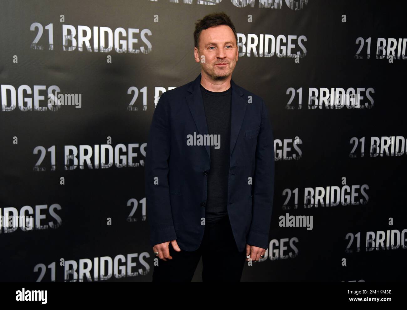 Brian Kirk, director of "21 Bridges," poses during a photo call for the film at the Four Seasons ...