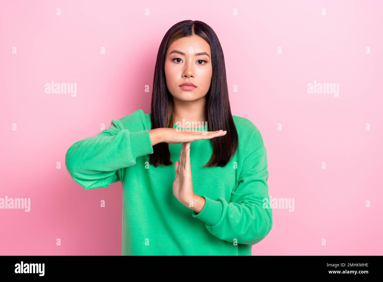 Photo of confident serious lady wear green sweatshirt showing arms ...