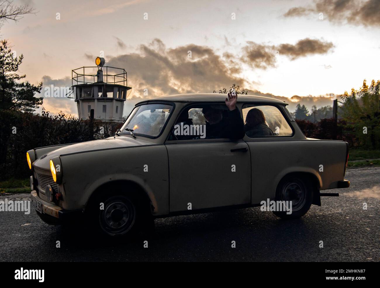 A legendary GDR Trabant (Trabi) carsdrive in front of a control tower ...