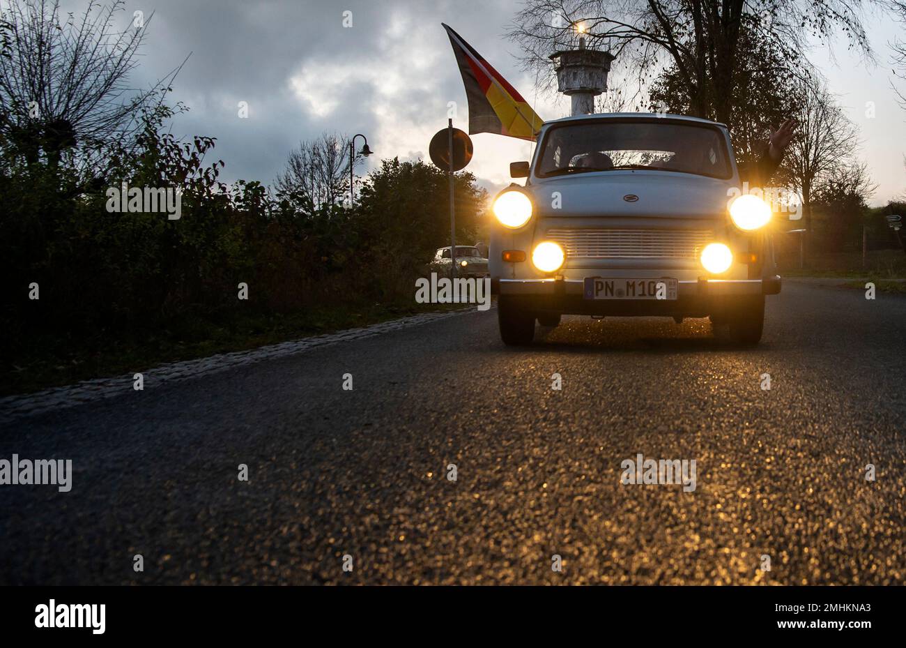 A legendary GDR Trabant (Trabi) carsdrive in front of a control tower ...