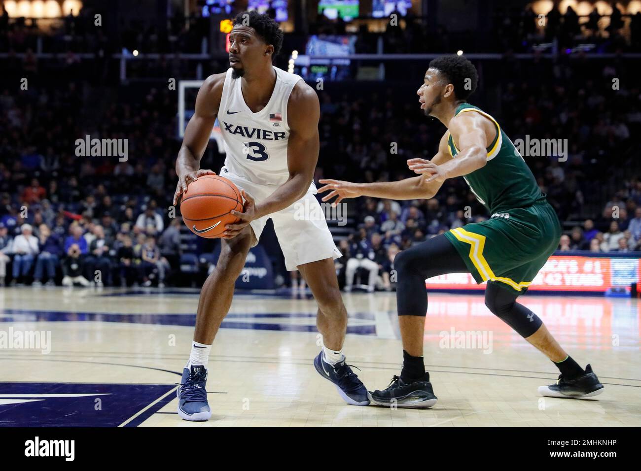 Xavier's Quentin Goodin (3) looks to pass against Siena's Donald Carey ...
