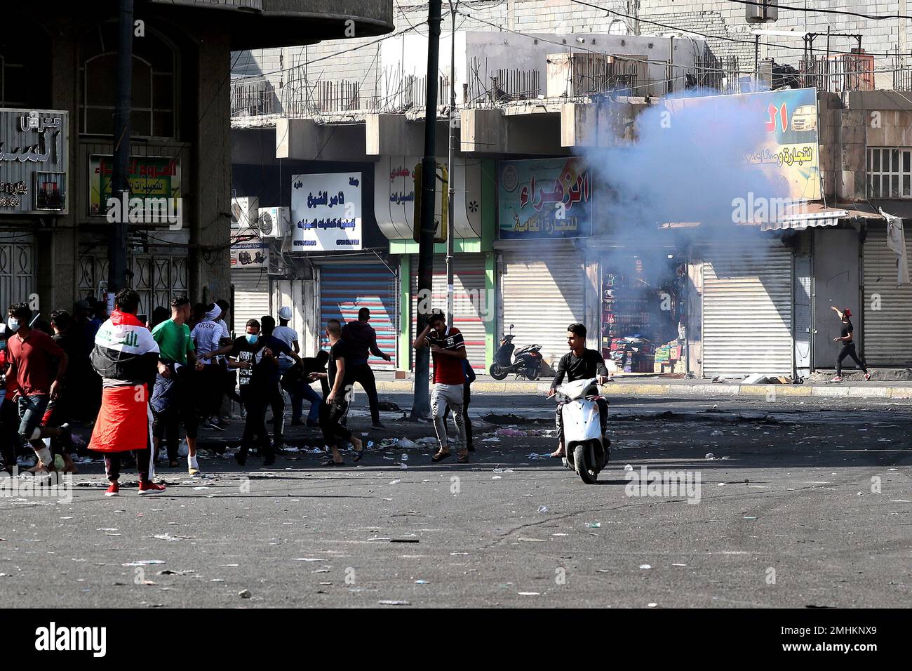 Tear gas is fired by Iraqi riot police to disperse anti-government ...