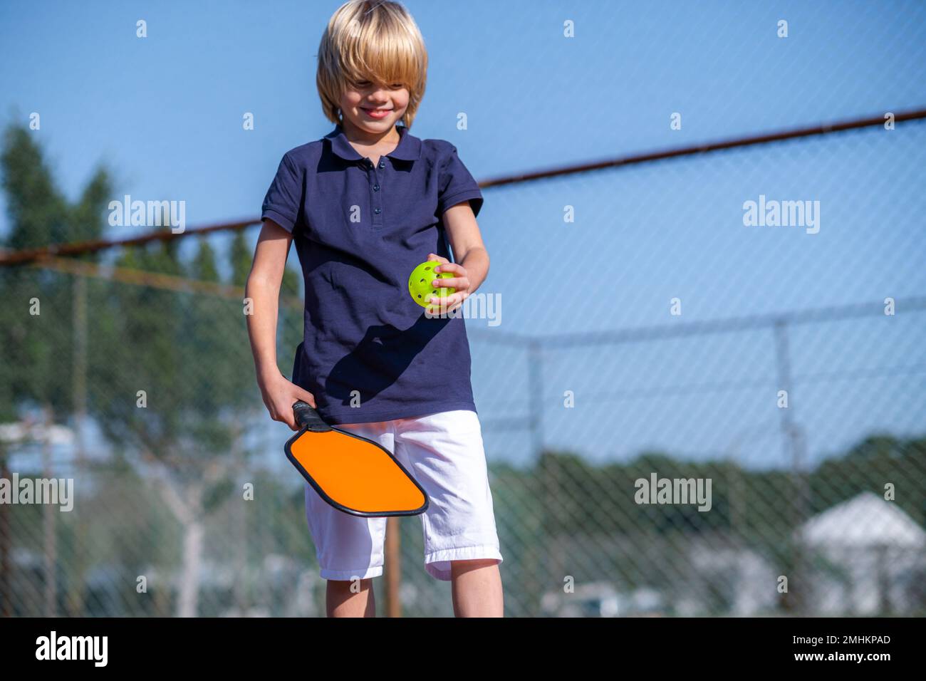 Happy blonde boy playing pickleball hi-res stock photography and images ...
