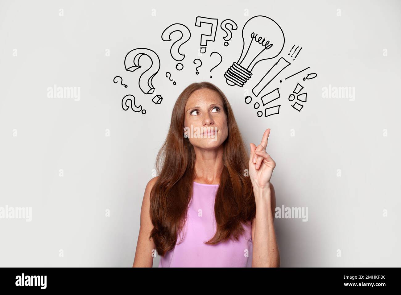 Pensive brunette woman with light bulbs and question marks above her ...