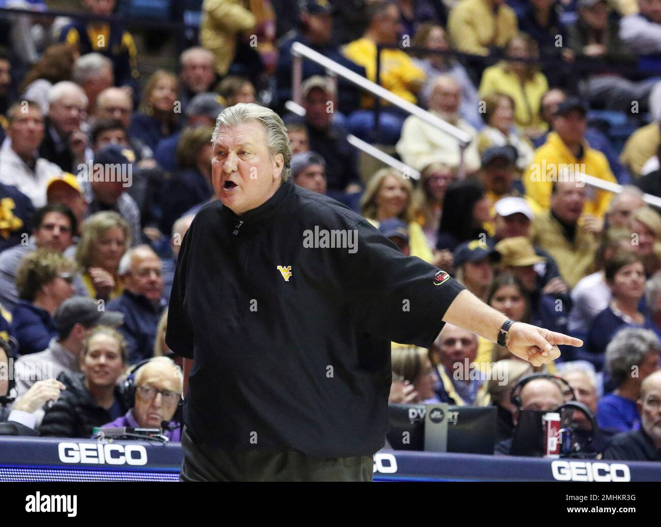 West Virginia head coach reacts during an NCAA college basketball game ...