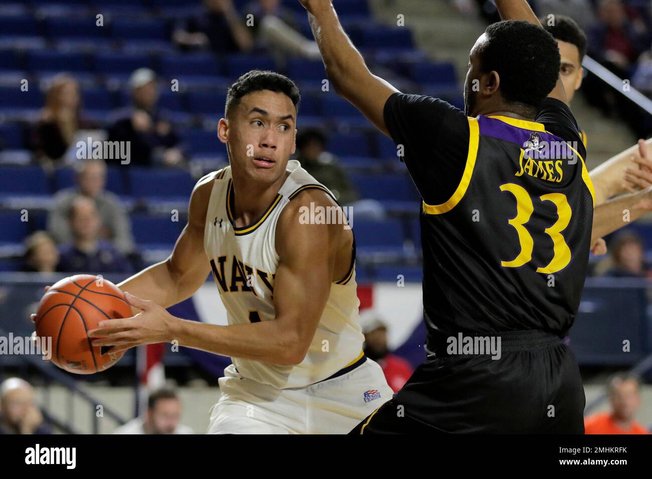 Navy guard John Carter Jr., left, drives in the paint against East ...