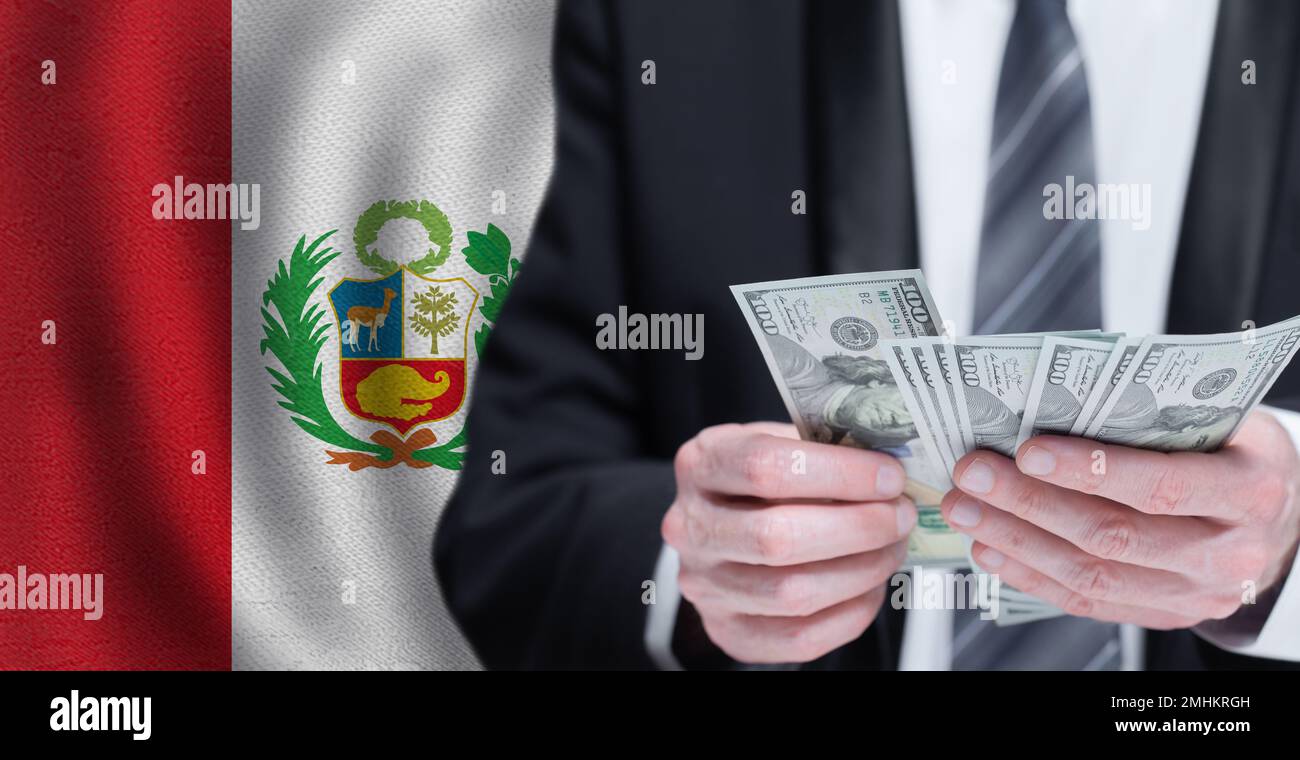 Hands holding dollar money on flag of Peru Stock Photo - Alamy