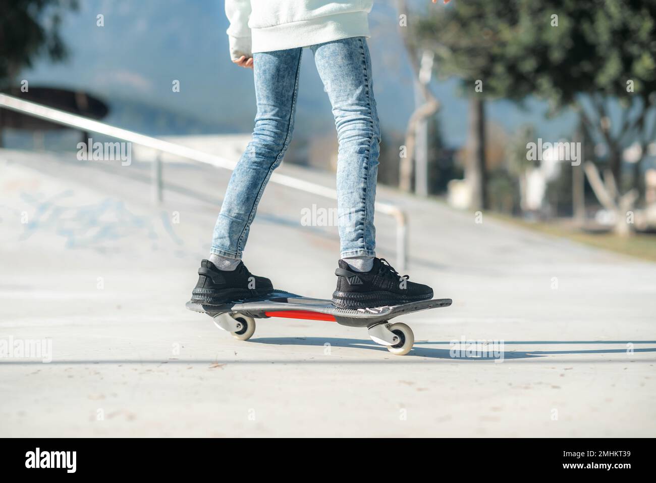 Legs on waveboard close up, Girl riding on casterboard with two wheels ...