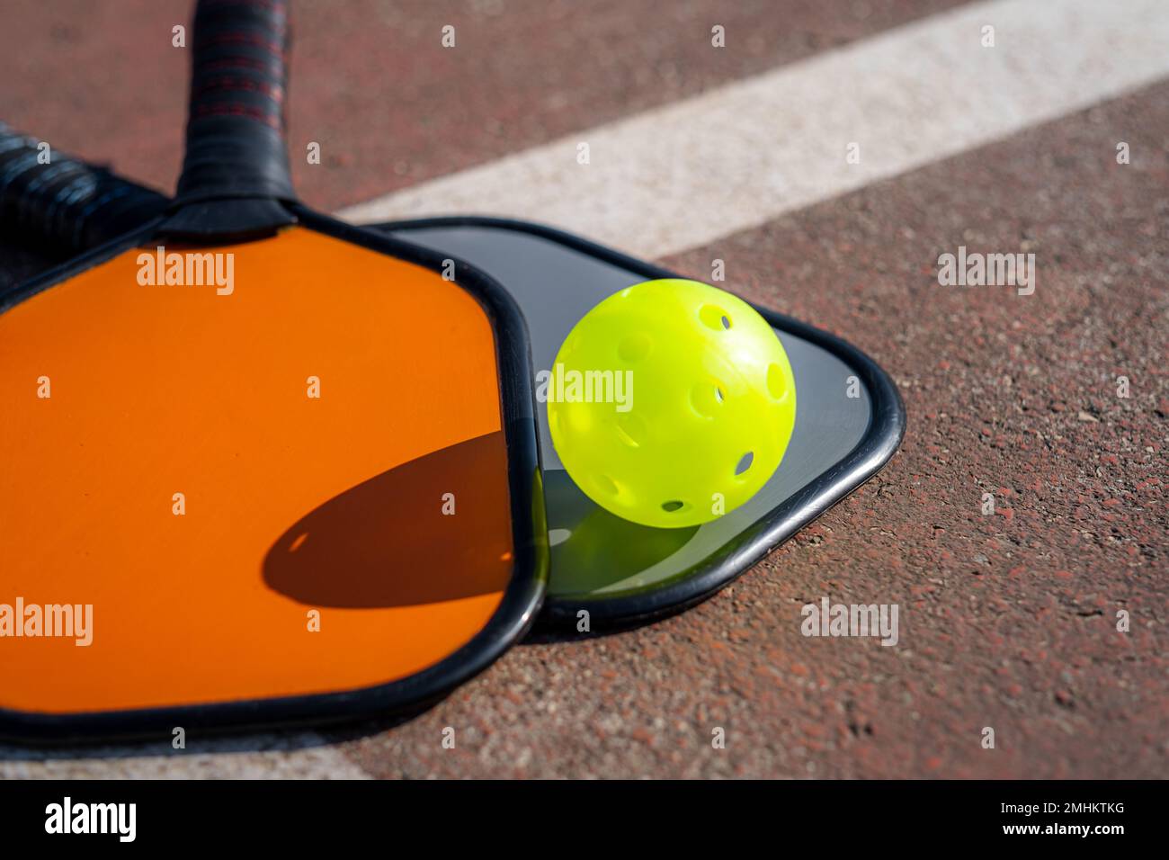pickleball game, colorful orange and grey pickleball paddle with yellow ...