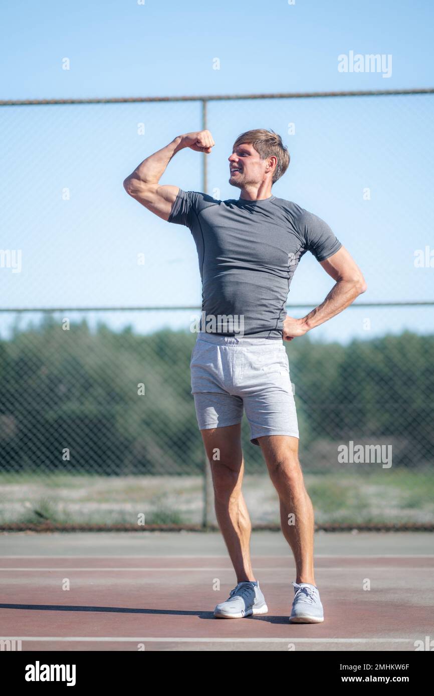 Strong biceps of man,, Athlete checking his muscles, doing sport ...