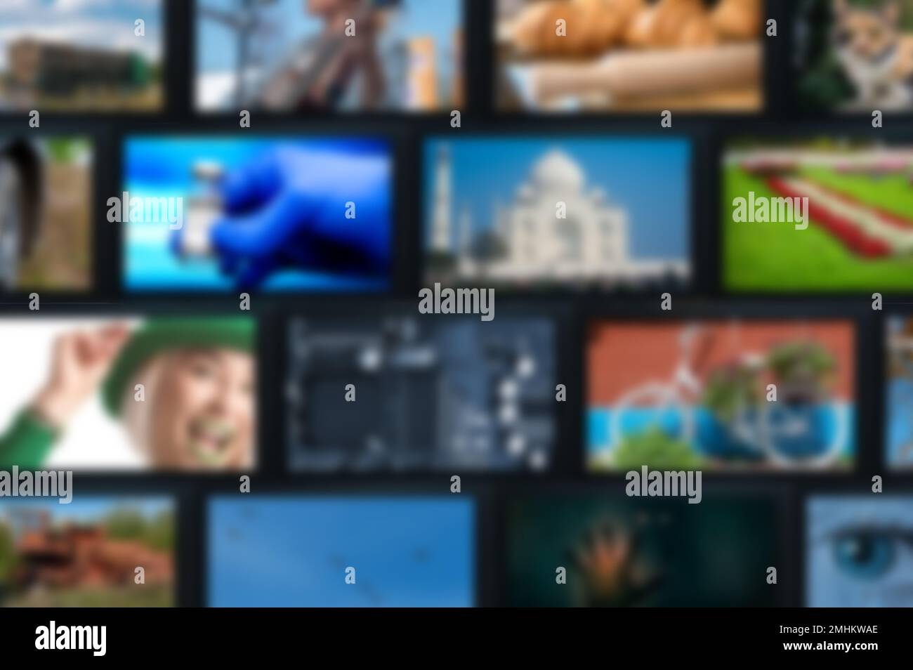 Background of many blurred TV screens. Master control room of TV ...