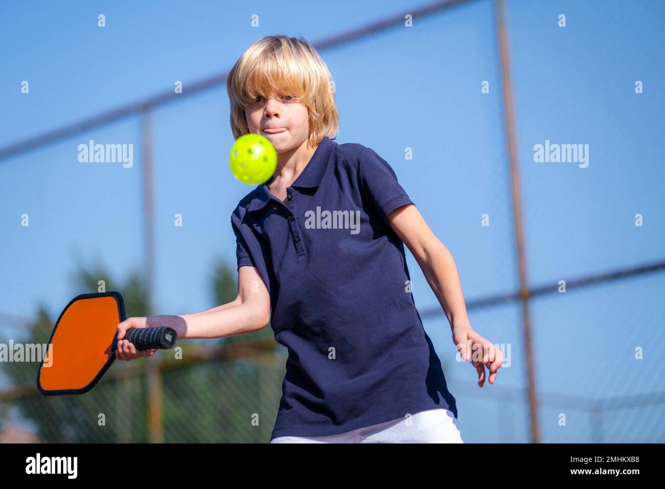 Happy blonde boy playing pickleball hi-res stock photography and images ...
