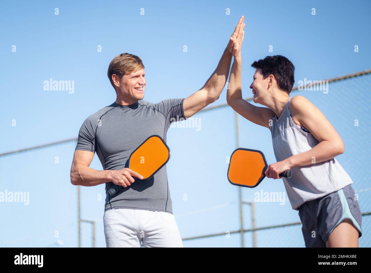 Laughing couple playing pickleball hi-res stock photography and images ...