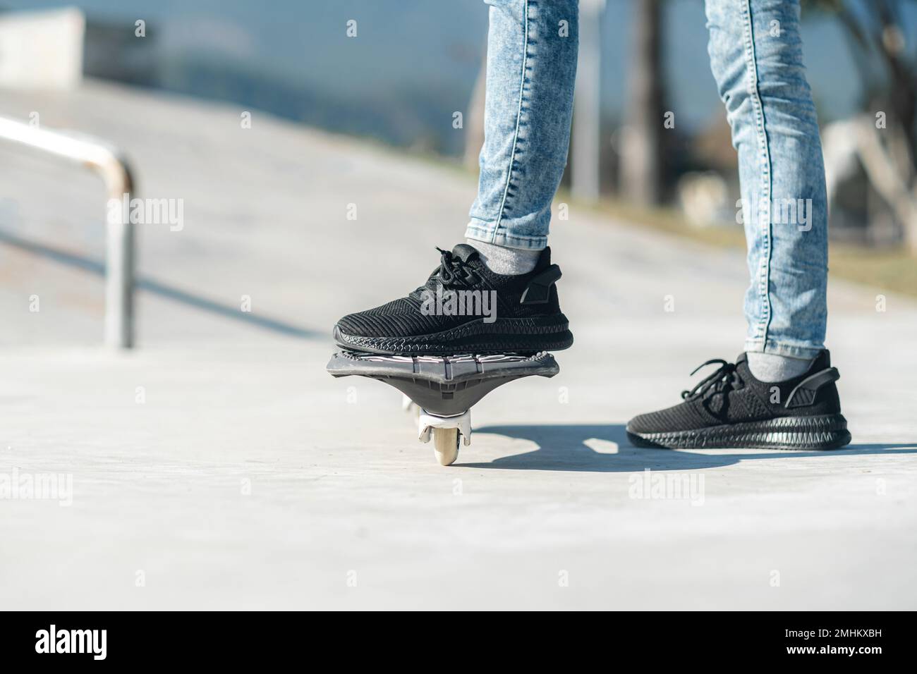 Legs on waveboard close up, Girl riding on casterboard with two wheels ...