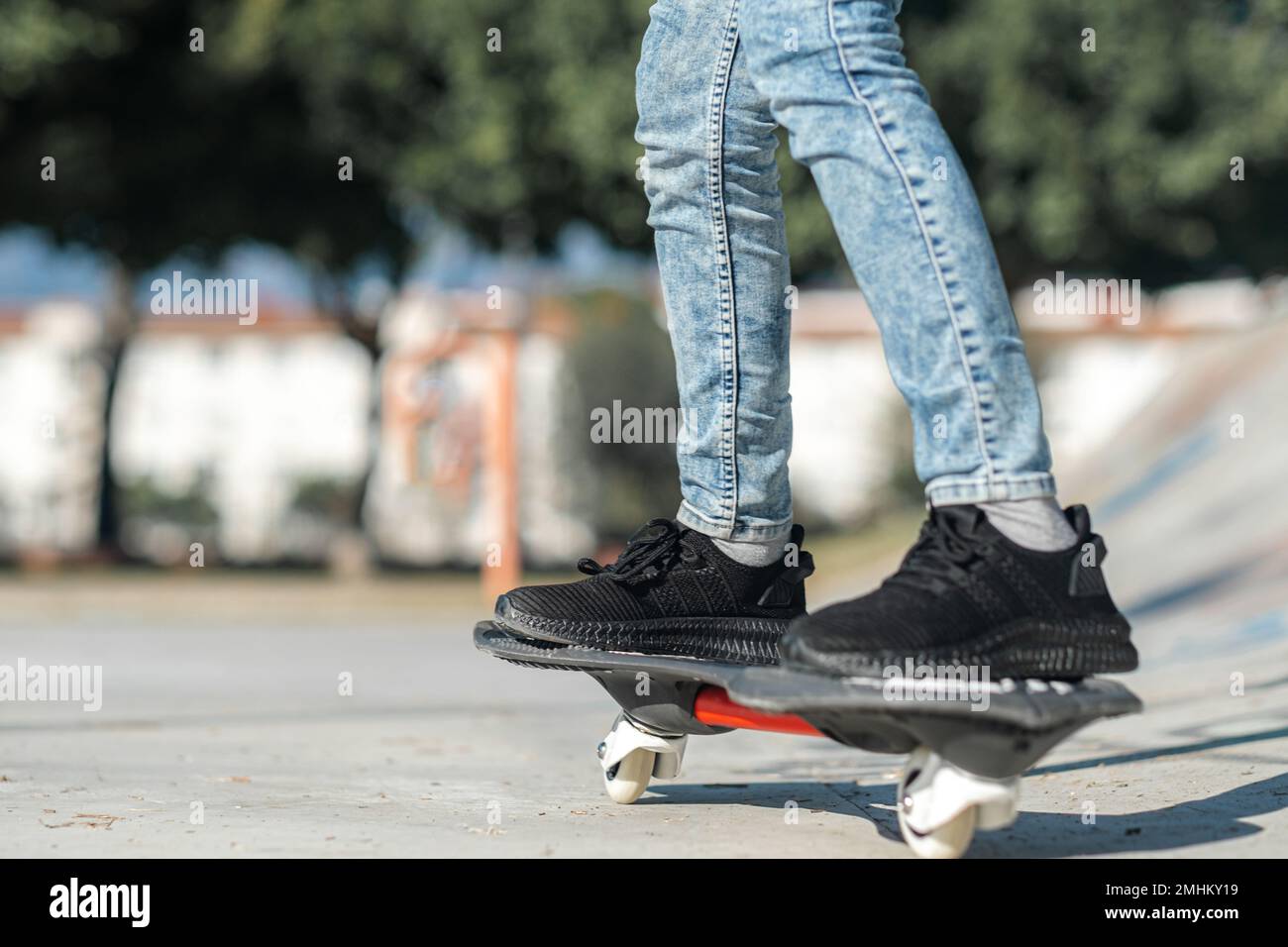 Legs on waveboard close up, Girl riding on casterboard with two wheels ...