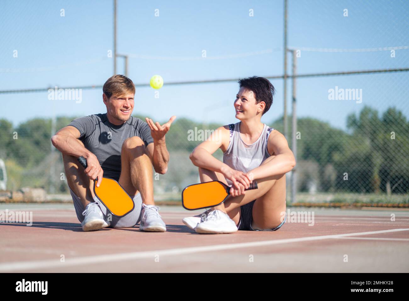 pickleball game, relaxing pickleball players couple with yellow ball ...