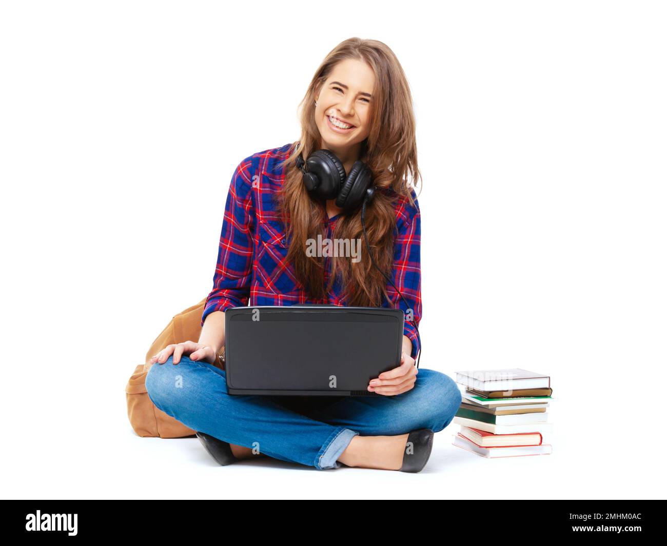 Portrait of happy female student sitting isolated on white background Stock Photo - Alamy