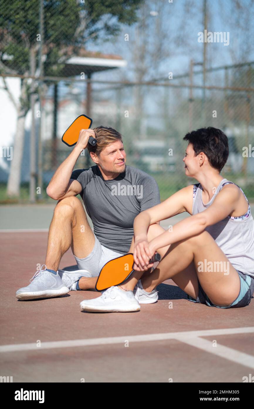 pickleball game, relaxing pickleball players couple with yellow ball ...