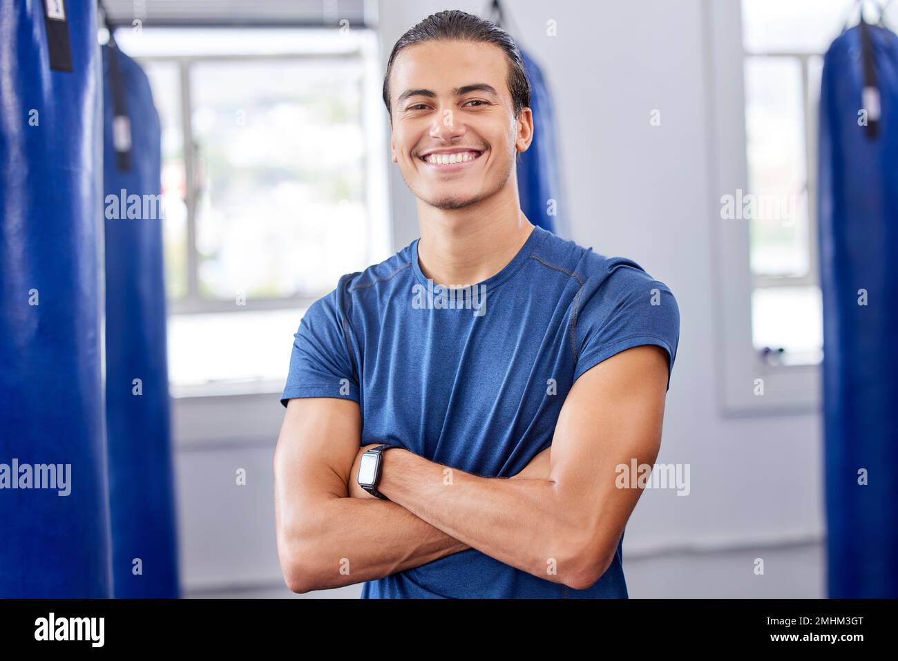 Personal trainer man, gym portrait and arms crossed with focus ...