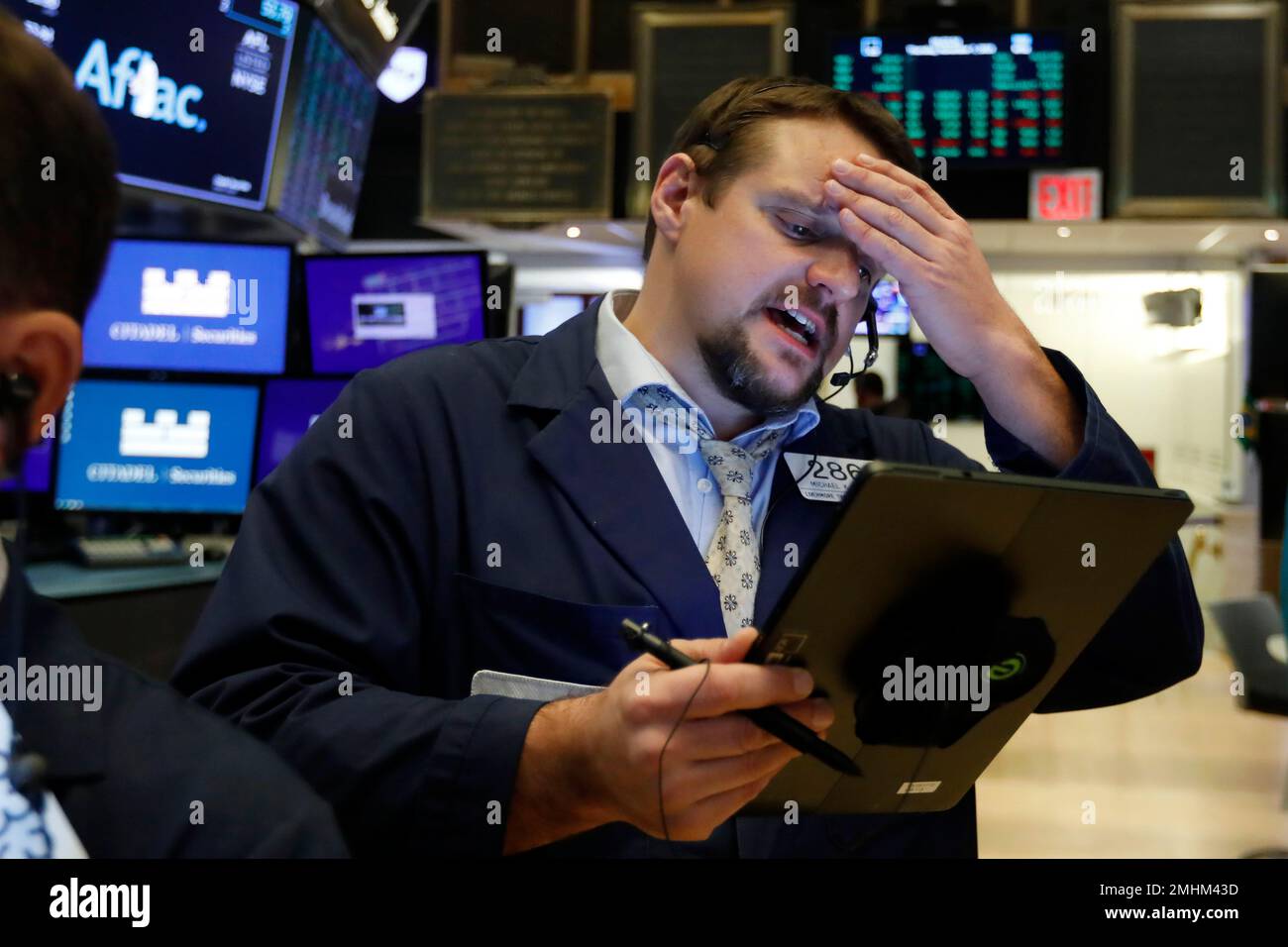 Trader Michael Milano works on the floor of the New York Stock Exchange ...