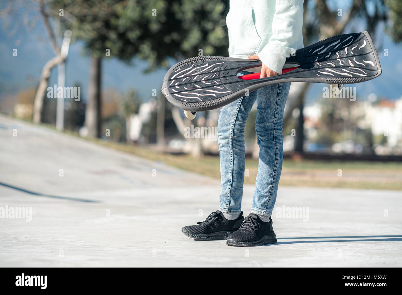 waveboard skater, Girl holds casterboard with two wheels, modern street ...