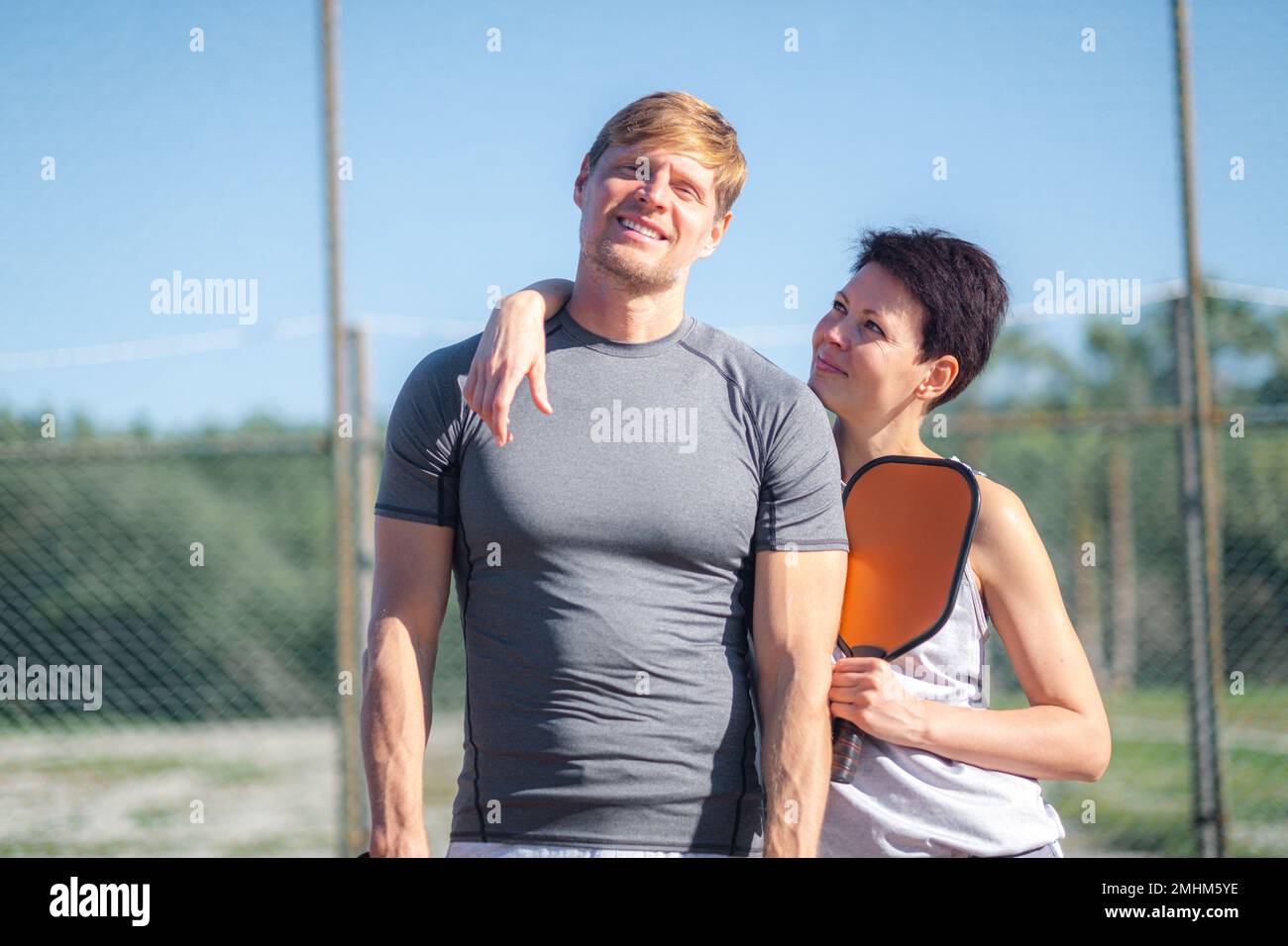 Portrait happy couple players pickleball game, pickleball yellow ball ...