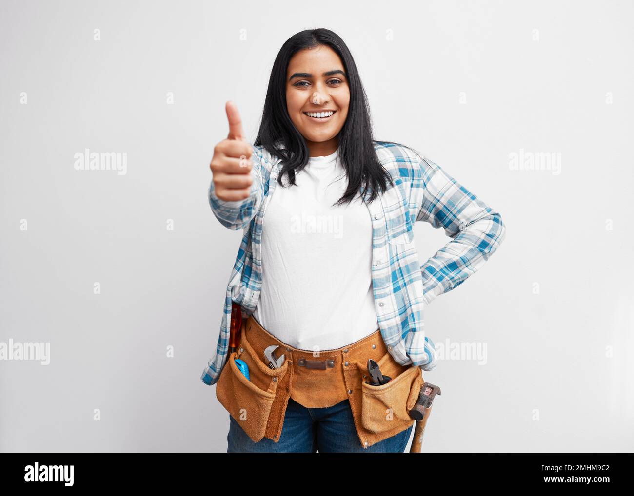 Portrait of a strong young Indian woman about to do DIY giving thumbs ...
