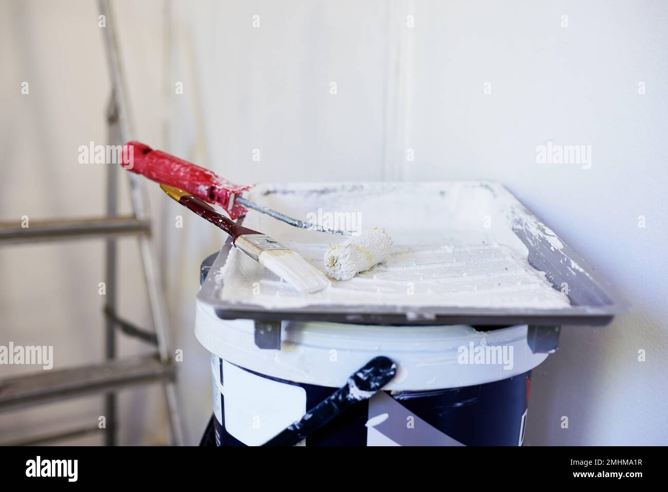 Still life of home painting project - brush, roller, paint tray, bucket ...
