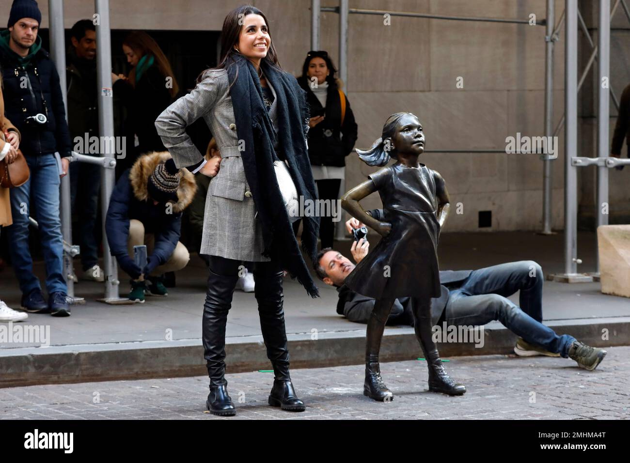 Women pose with the Fearless Girl statue facing the New York Stock ...