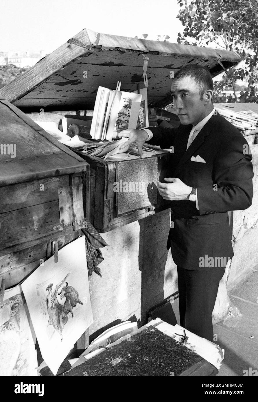 The Japanese writer Yukio Mishima looking through prints artists sell ...