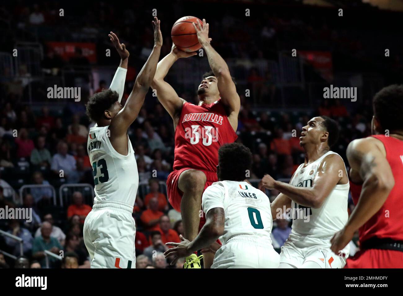 Louisville forward Jordan Nwora (33) shoots over Miami guard Kameron ...