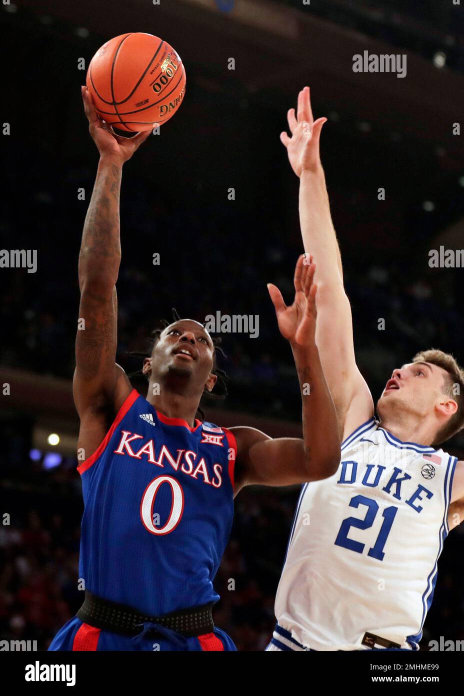 Kansas guard Marcus Garrett (0) drives to the basket past Duke forward ...
