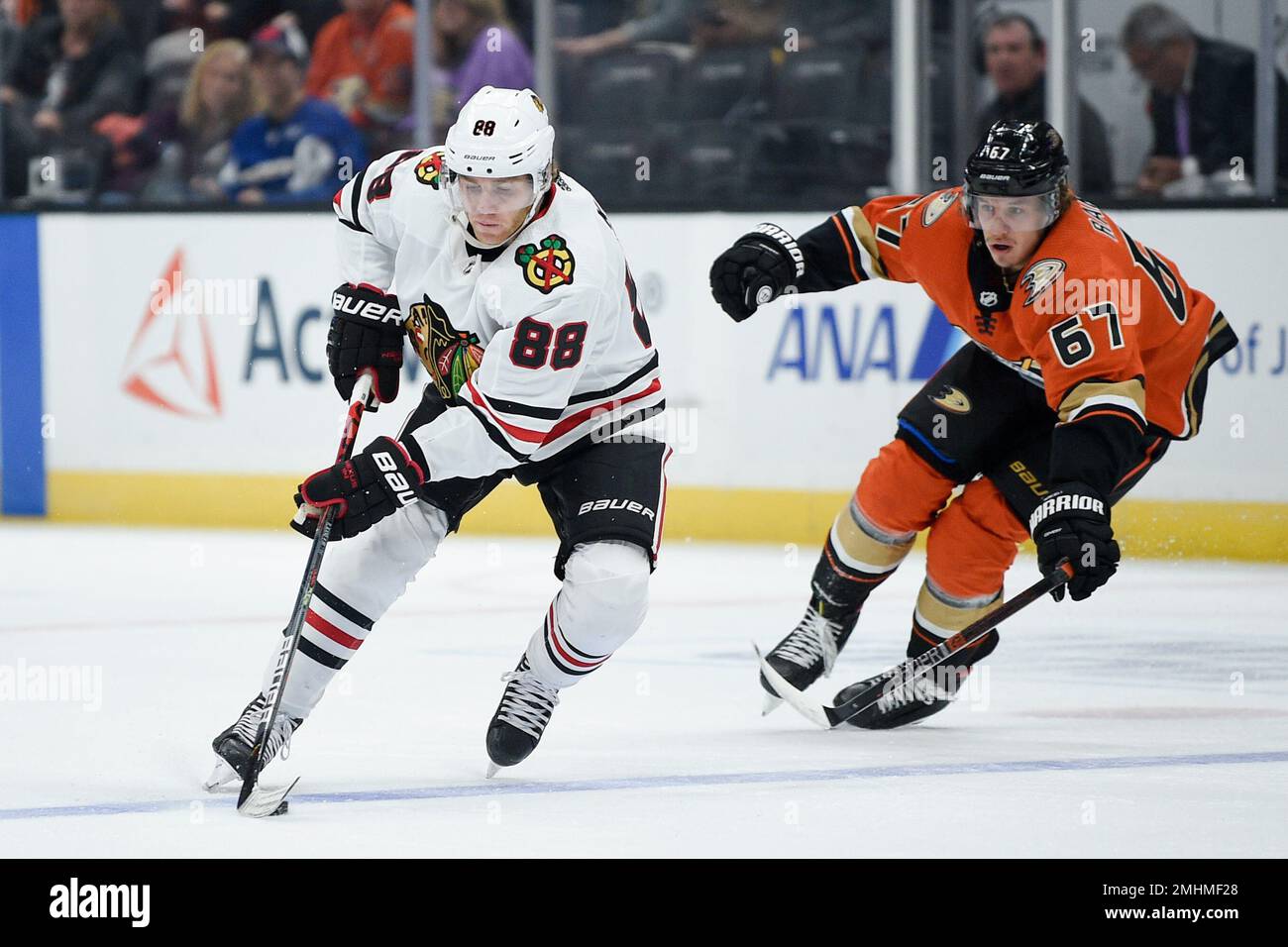 Chicago Blackhawks right wing Patrick Kane, left, handles the puck past ...