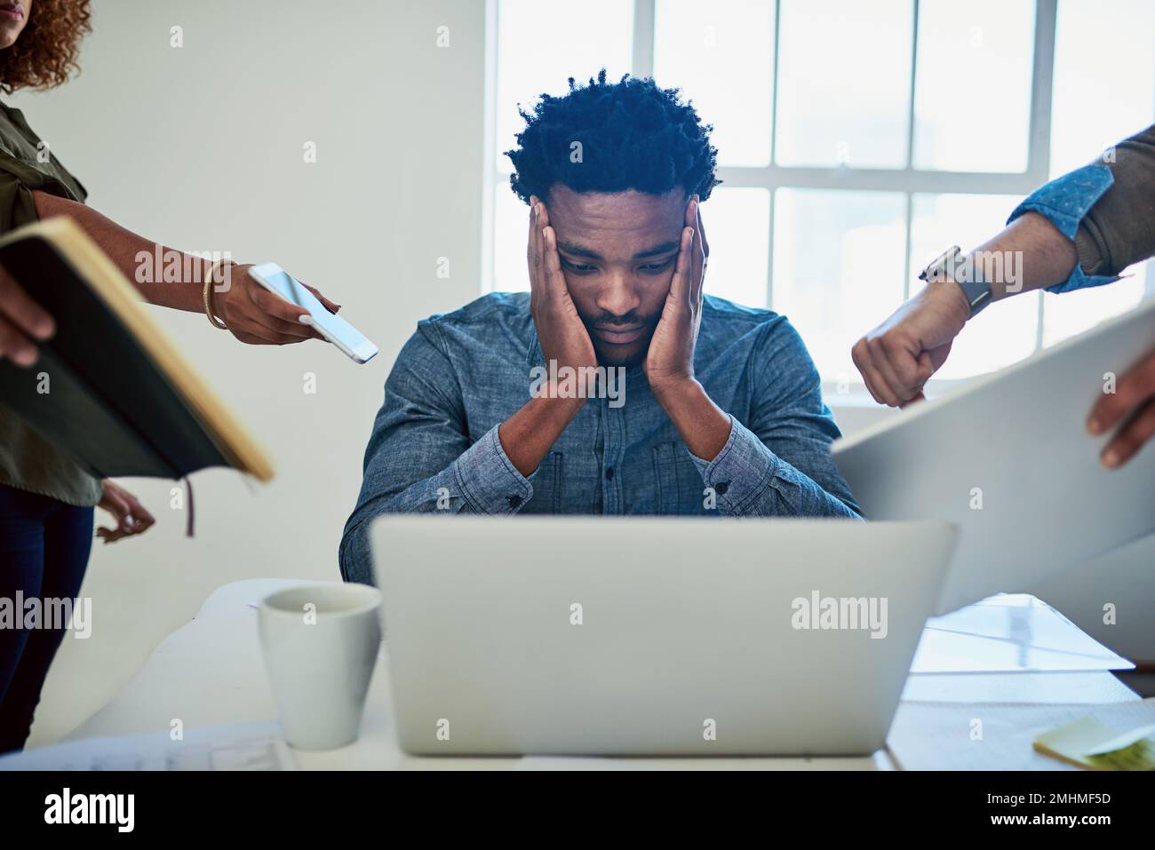 The demands of work are bringing him down. a stressed out young man ...