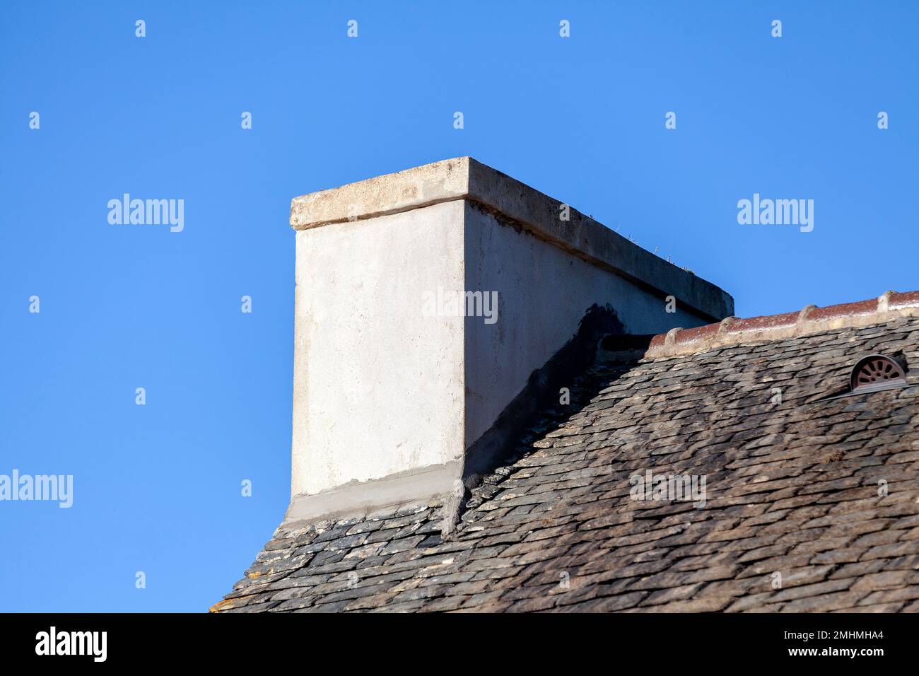 Repair of a chimney flashing on an old slate roof Stock Photo - Alamy