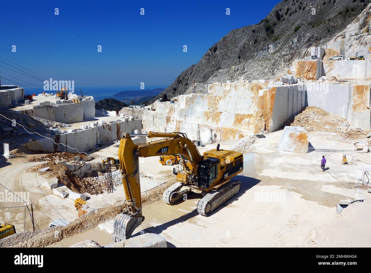 Workers cutting marble blocks in the Carrara marble quarry, Carrara ...