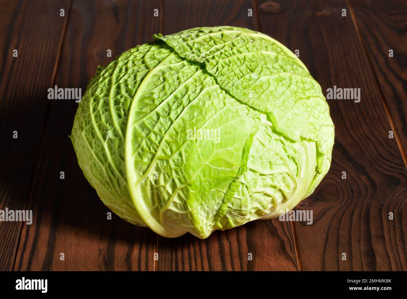 savoy cabbage on wood background Stock Photo - Alamy