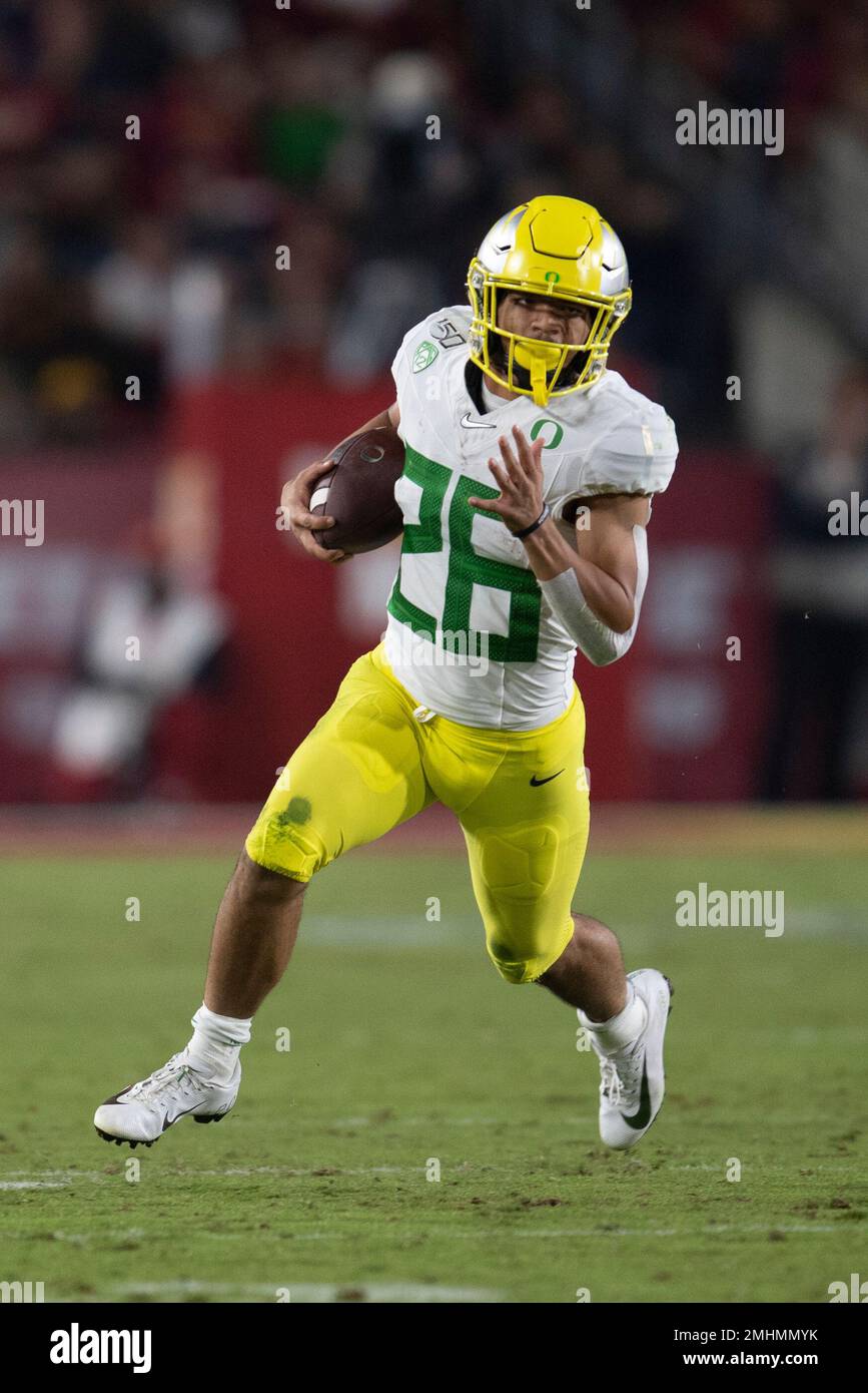 Oregon running back Travis Dye sprints with the ball in an NCAA college ...