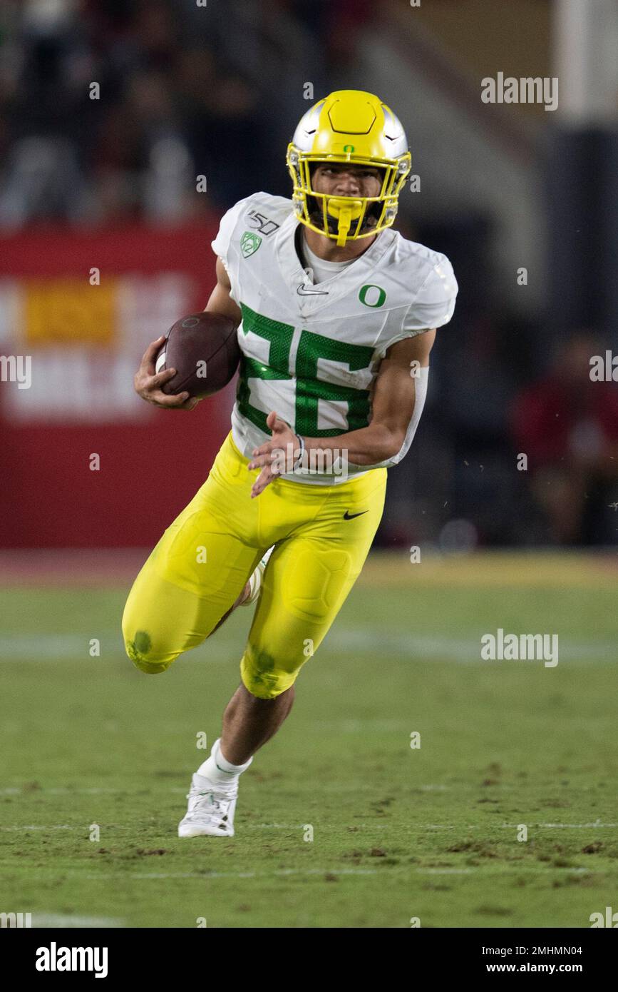 Oregon running back Travis Dye sprints with the ball in an NCAA college ...