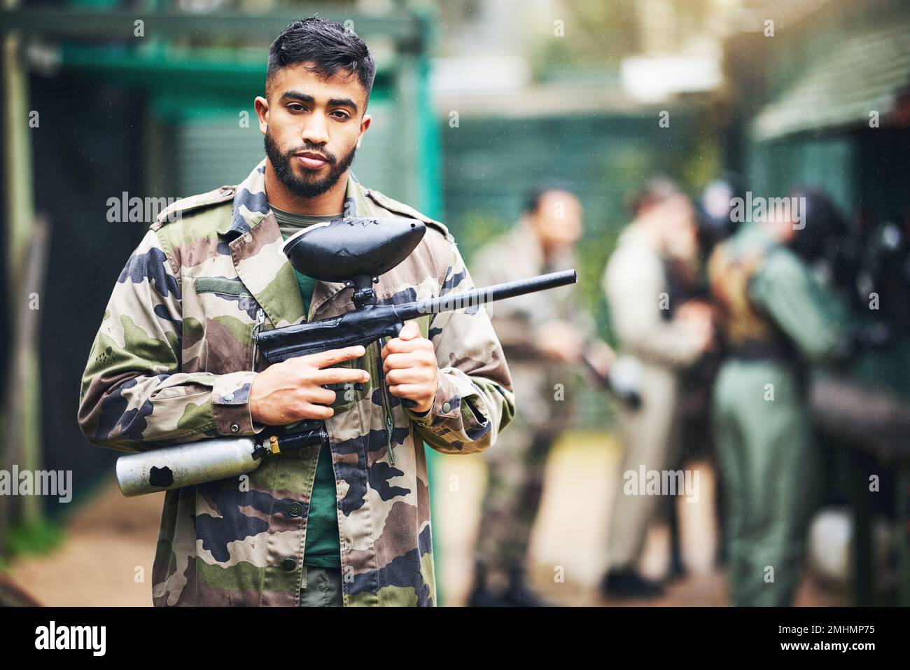 Paintball game and portrait of a man with gun and safety uniform for ...