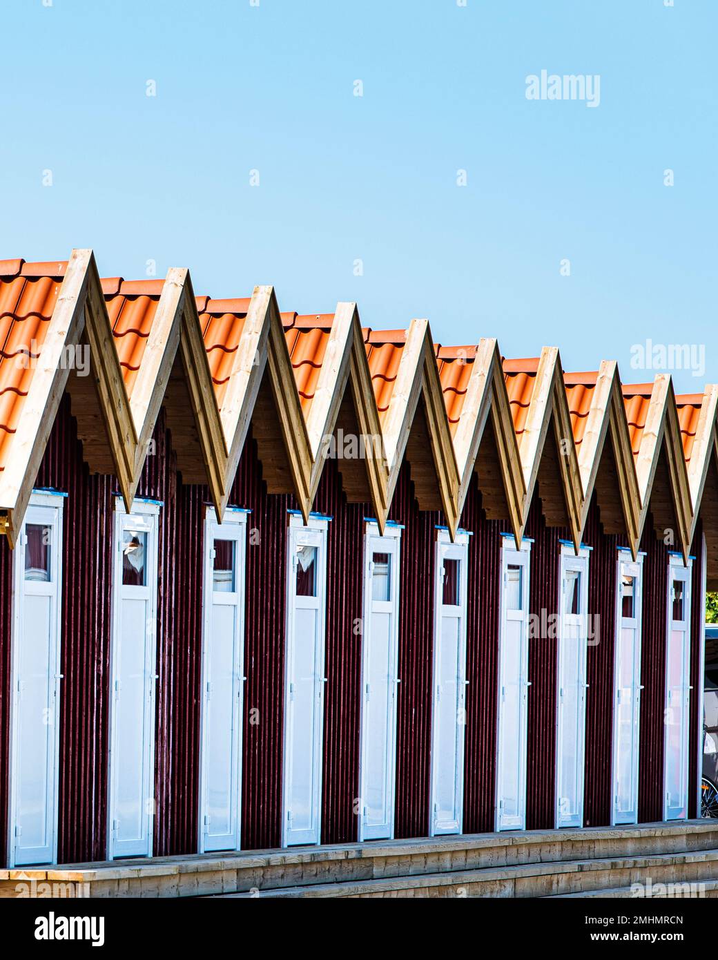 Scandinavian architecture with row of red summerhouses in Fotö hamn ...