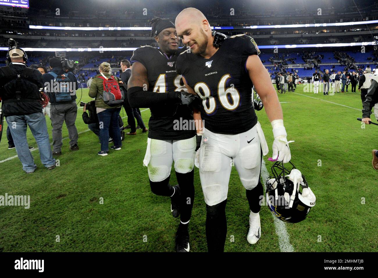 Baltimore Ravens linebacker Patrick Onwuasor (48) walks with tight end ...